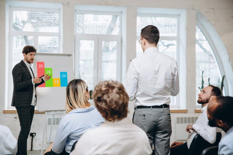 Male Speaker Giving Presentation in Hall at Workshop. Audience or ...