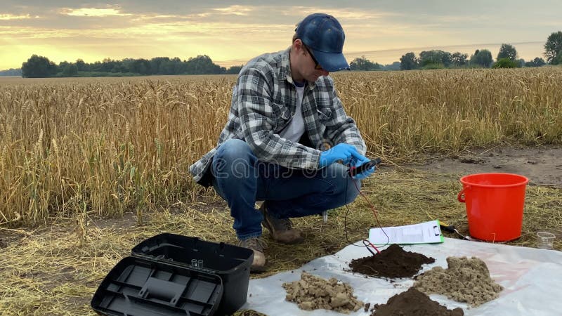 Male Specialist Measuring Soil Features by Using Soil Tester, Tablet ...