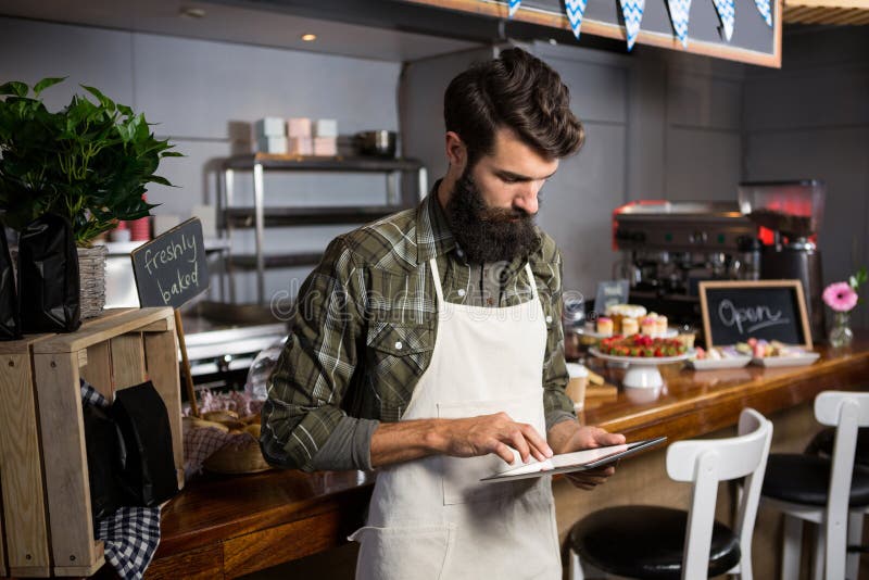 Male Staff Using Digital Tablet at Counter Stock Image - Image of adult ...
