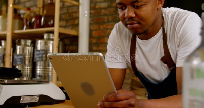 Male Staff Using Digital Tablet at Counter in Supermarket Stock Image ...