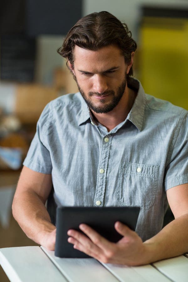 Male Staff Using Digital Tablet in Grocery Shop Stock Photo - Image of ...