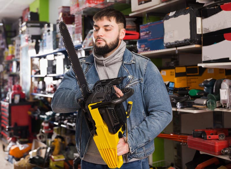 Male is Standing with New Chainsaw in Tools Store Stock Photo - Image ...