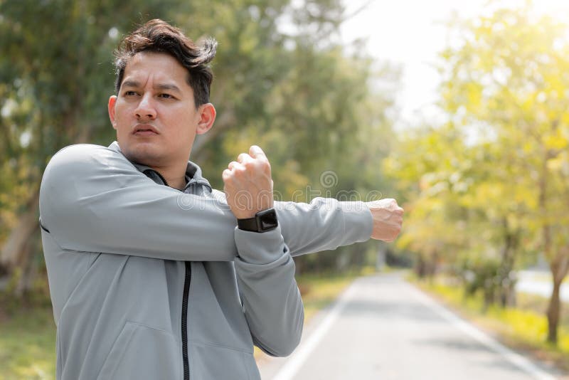 Male is Stretching Arm and Relaxing before Running in the Morning Stock ...