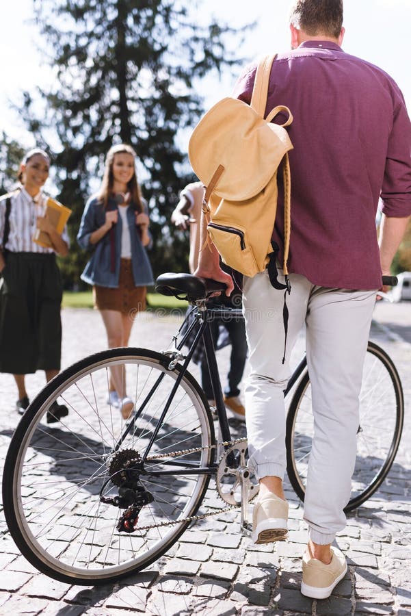 Male student with bicycle stock image. Image of together - 99424761