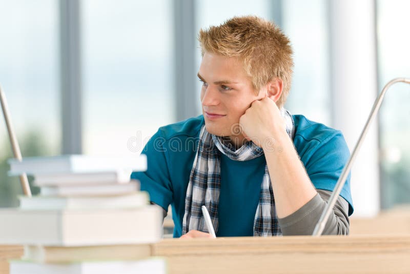 Male Student with Books Sitting at Table Stock Photo - Image of student ...