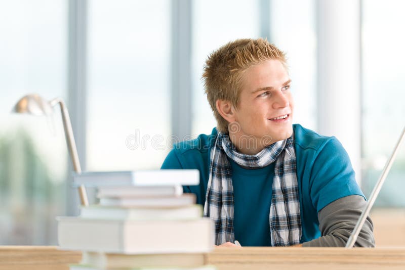 Male Student with Books Sitting at Table Stock Photo - Image of student ...