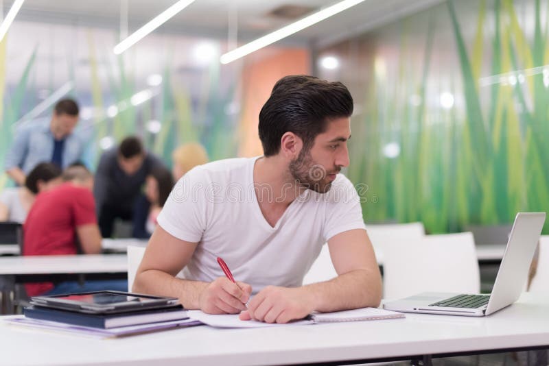 Male Student Taking Notes in Classroom Stock Photo - Image of academic ...
