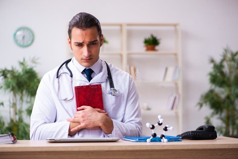Young Male Student Doctor Reading Book in the Clinic Stock Image ...