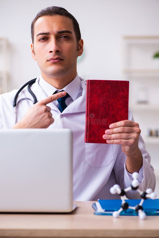 Young Male Student Doctor Reading Book in the Clinic Stock Image ... Young Male Student Doctor Reading Book in the Clinic Stock Image ...