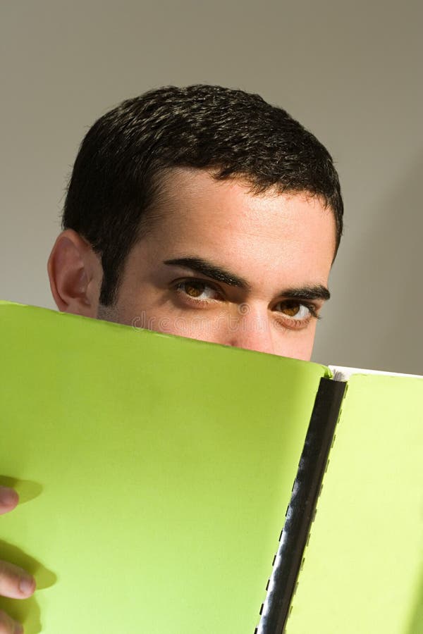 Male Student Hiding Behind a Book Stock Image - Image of people ...