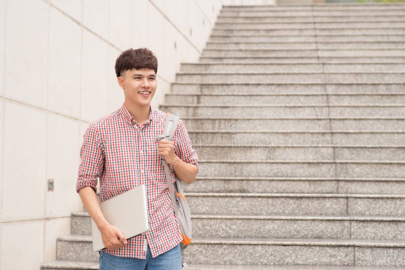 Male Student Hold with Laptop Computer at University Campus Stock Photo ...
