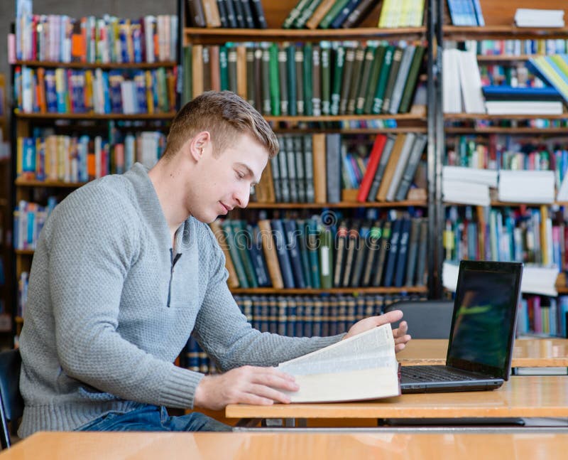 Male Student with Laptop Studying in the University Library Stock Image ...