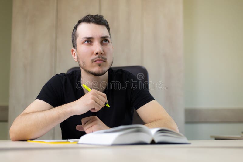 Male Student in the Learning Process with a Pen and Abstract Stock ...