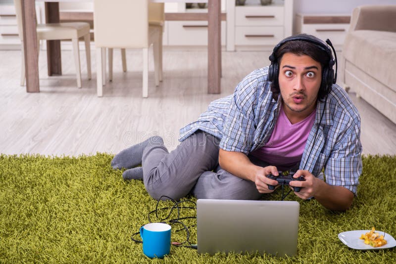 Young Male Student Playing Computer Games at Home Stock Photo - Image ...