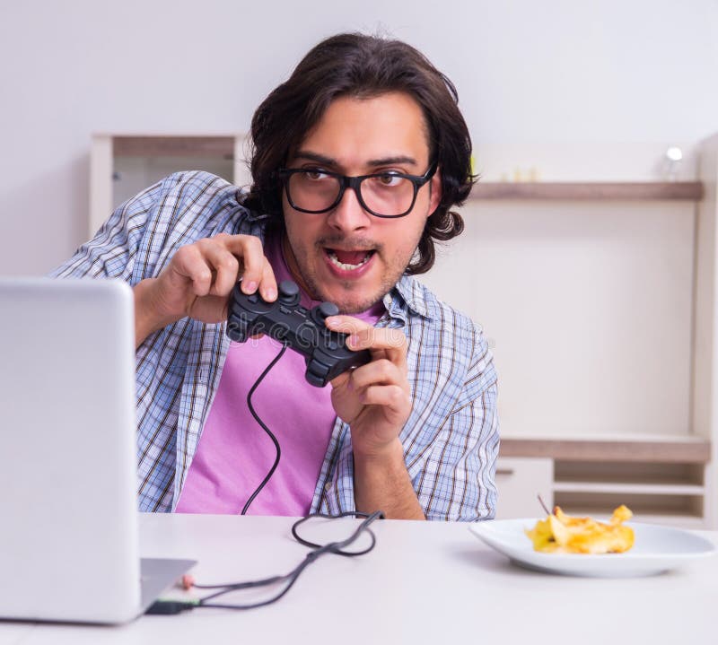 Young Male Student Playing Computer Games at Home Stock Photo - Image ...