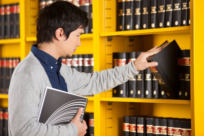Male Student Selecting Book in Library Stock Photo - Image of asian ...