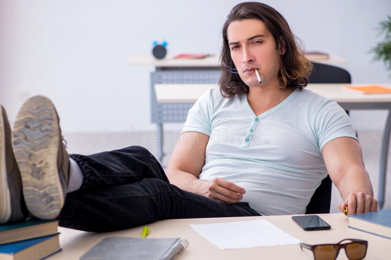 Young Male Student Smoking Cigarettes in the Classroom Stock Image ...