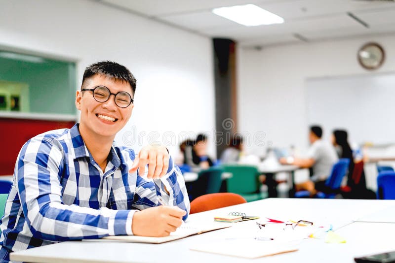 Male Student Study in the Campus | Smiling and Doing Homework Stock ...