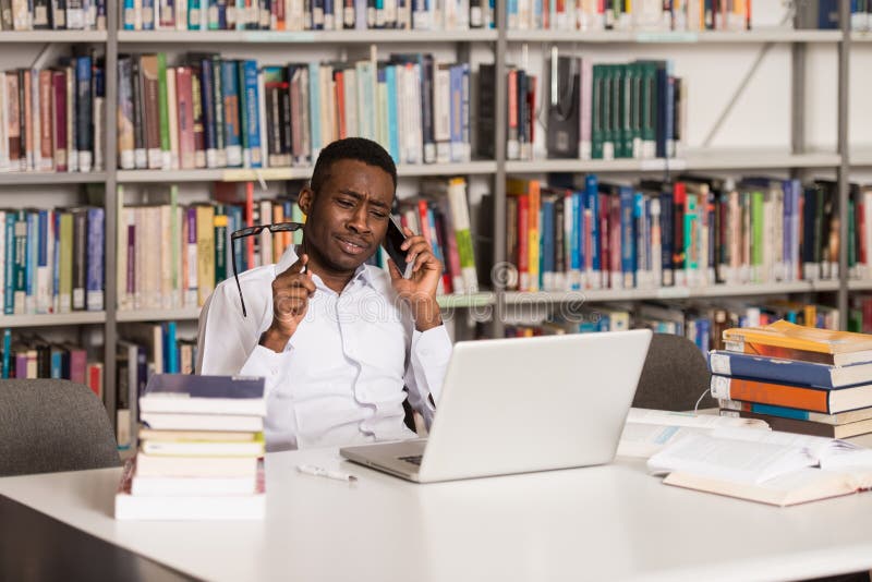 Male Student Talking on the Phone in Library Stock Image - Image of ...