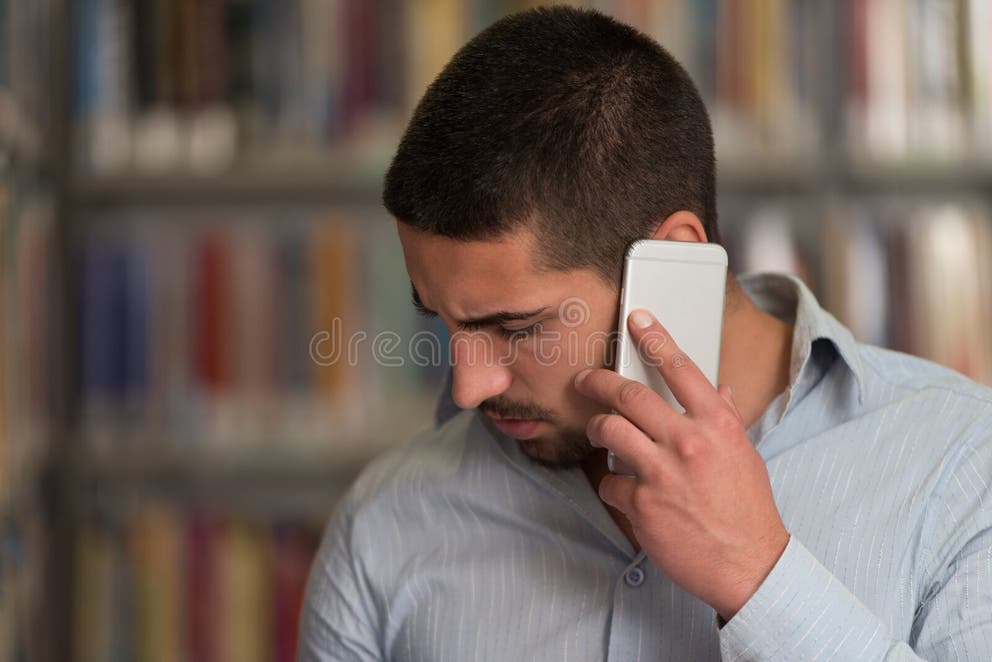 Male Student Talking on the Phone in Library Stock Photo - Image of ...