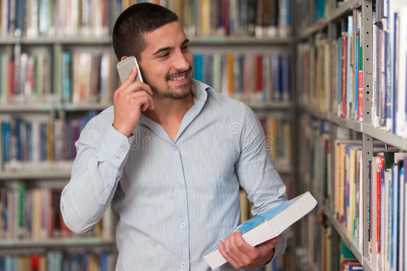 Male Student Talking on the Phone in Library Stock Image - Image of ...