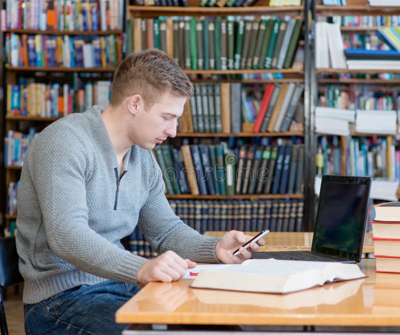 Male Student Texting on the Phone in the University Library Stock Photo ... Male Student Texting on the Phone in the University Library Stock Photo ...
