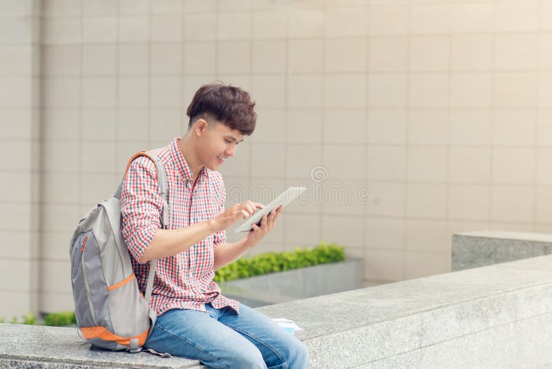 Male Student Using Digital Tablet in College Campus Stock Photo - Image ...