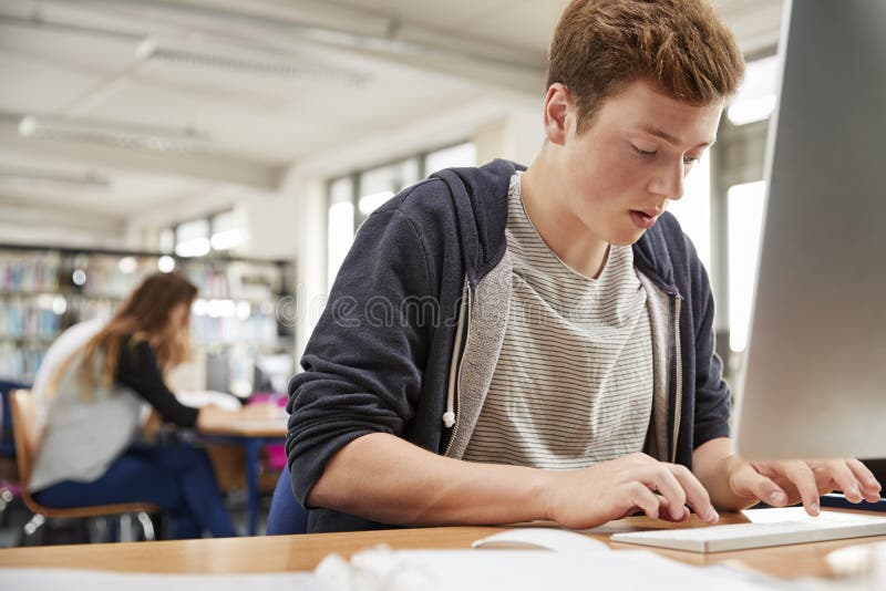 Male Student Working on Computer in College Library Stock Image - Image ...