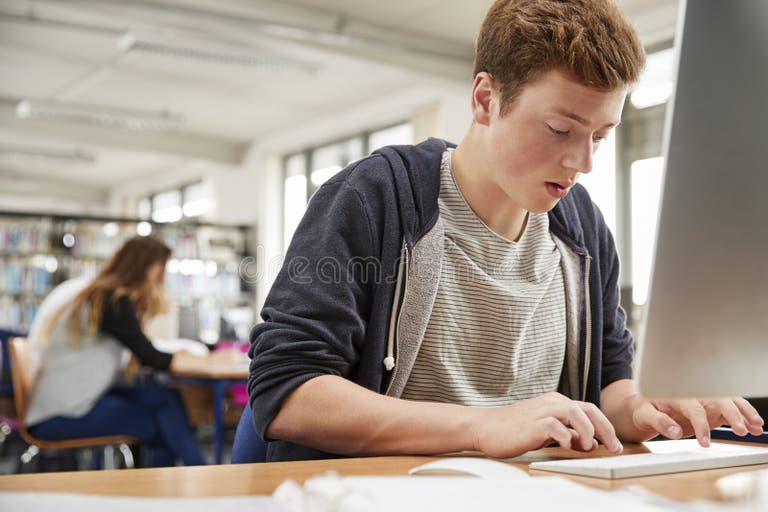 Male Student Working on Computer in College Library Stock Image - Image ...