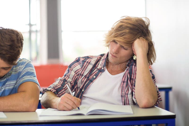 Male Student Writing Notes in Classroom Stock Image - Image of academic ...