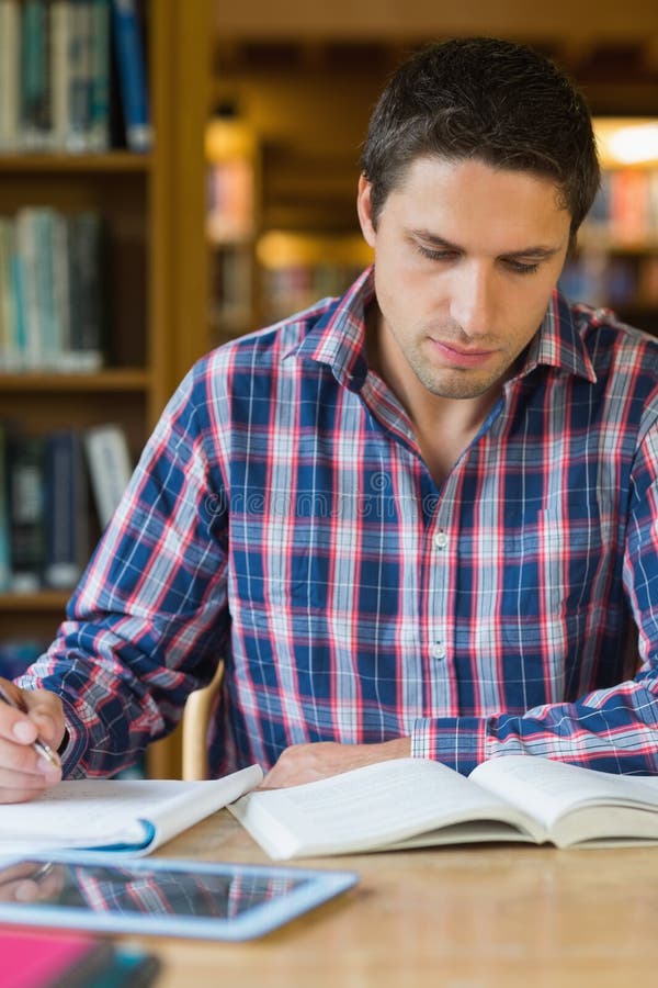 Male Student Writing Notes at Desk in the Library Stock Image - Image ...