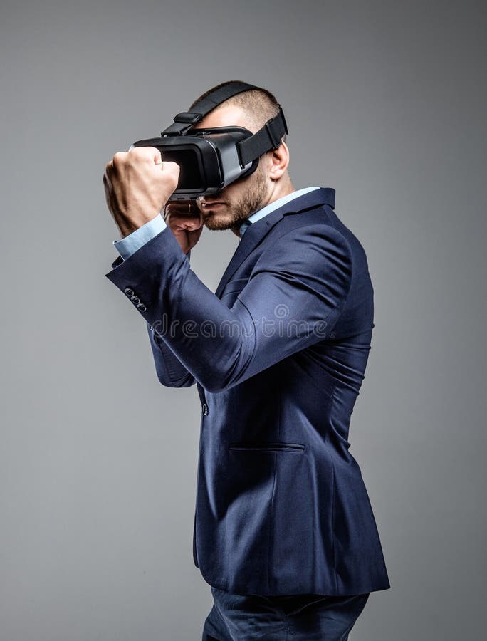 Male in a Suit Fighting with Virtual Reality Glasses on His Head Stock ...