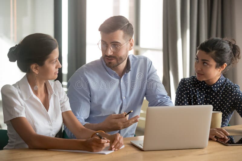 Male Supervisor Talk Explaining Project on Laptop To Colleagues Stock ...