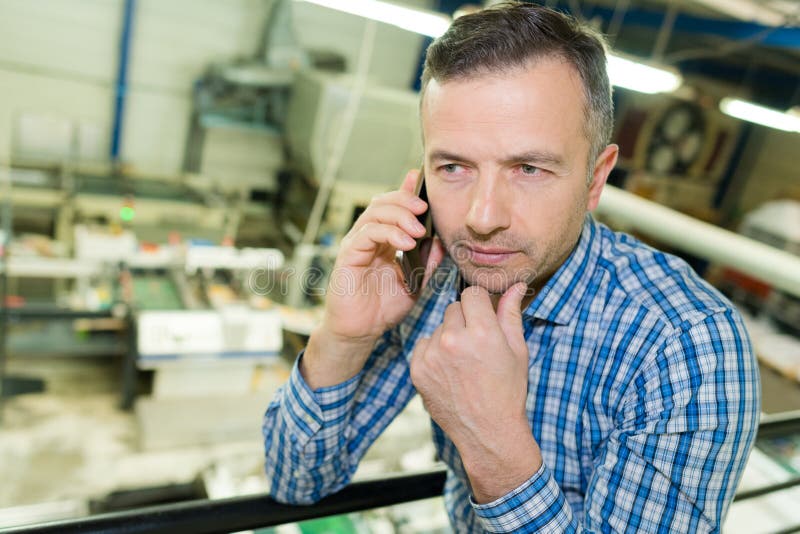 Male Supervisor Talking on Mobile Phone in Industry Stock Image - Image ...