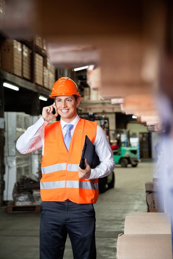 Male Supervisor Using Cell Phone at Warehouse Stock Image - Image of ...