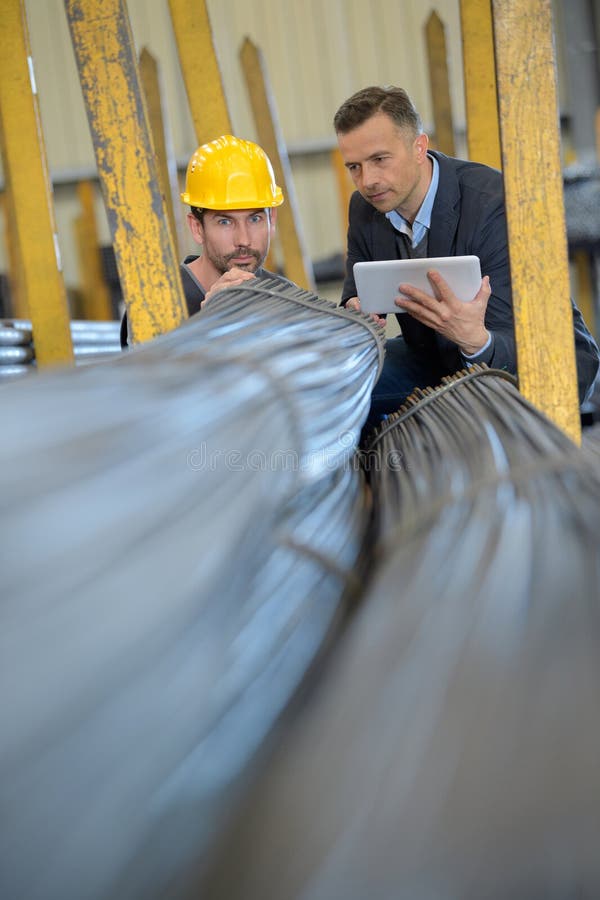 Male Supervisor with Worker Discussing in Industry Stock Photo - Image ...