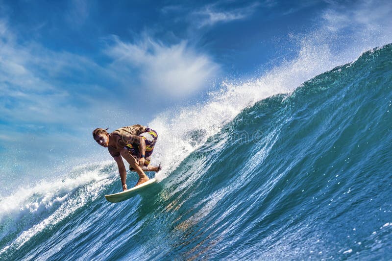 Male surfer on a blue wave stock photo. Image of freedom - 368598760