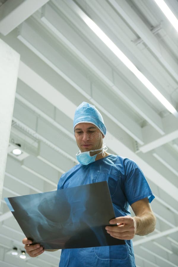 Male Surgeon Examining X-ray Stock Photo - Image of modern, holding ...
