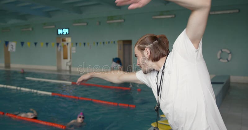 Coach Practise With Swimmer In The Indoor Swimming Pool Stock Footage