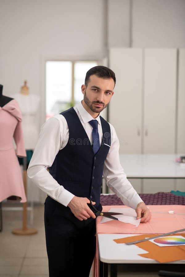Male Tailor Cutting Out Paper Pattern Over Table Stock Photo - Image of ...