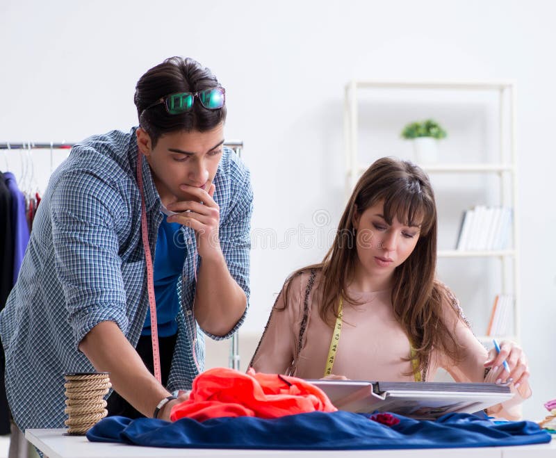 Male Tailor with Female Student in Workshop Stock Photo - Image of ...