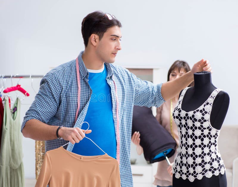 Male Tailor with Female Student in Workshop Stock Photo - Image of ...