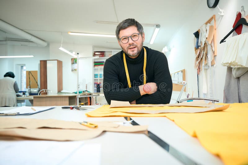 Male Tailor Stands at a Cutting Table in Sewing Studio Stock Photo ...