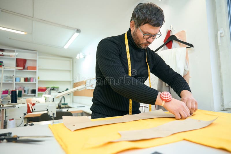 Male Tailor Works with Fabrics and Patterns at the Cutting Table Stock ...