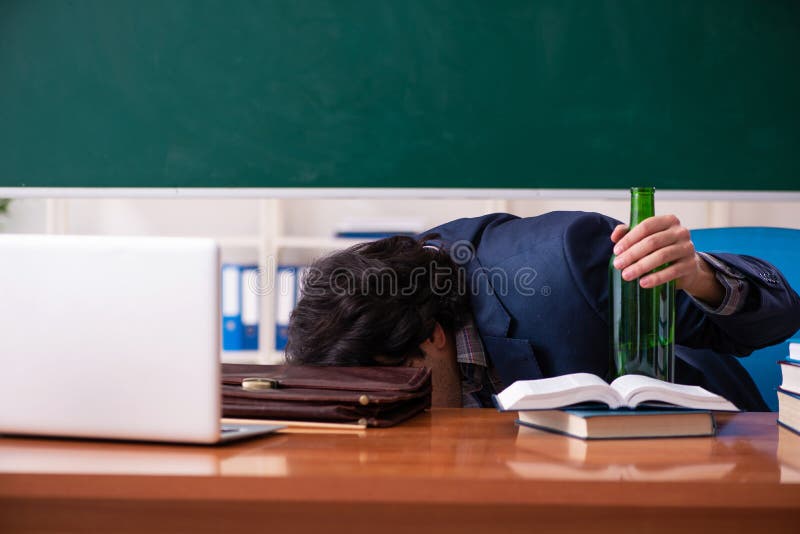 The Male Teacher Drinking in the Classroom Stock Photo - Image of ...