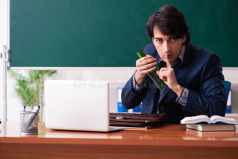 The Male Teacher Drinking in the Classroom Stock Photo - Image of ...