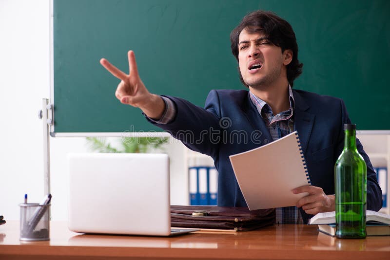 The Male Teacher Drinking in the Classroom Stock Photo - Image of ...