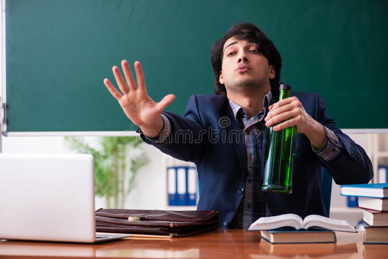 The Male Teacher Drinking in the Classroom Stock Photo - Image of ...