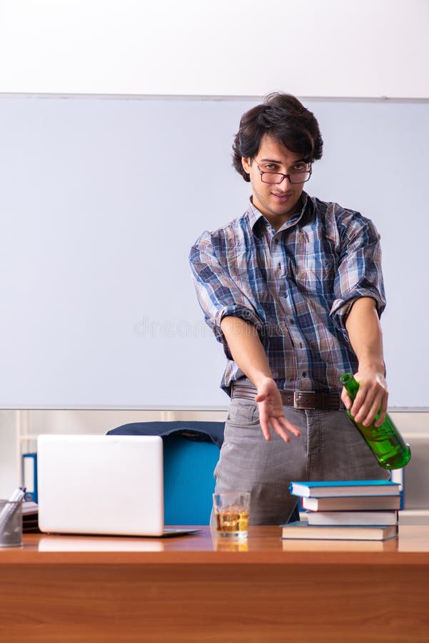 The Male Teacher Drinking in the Classroom Stock Photo - Image of ...