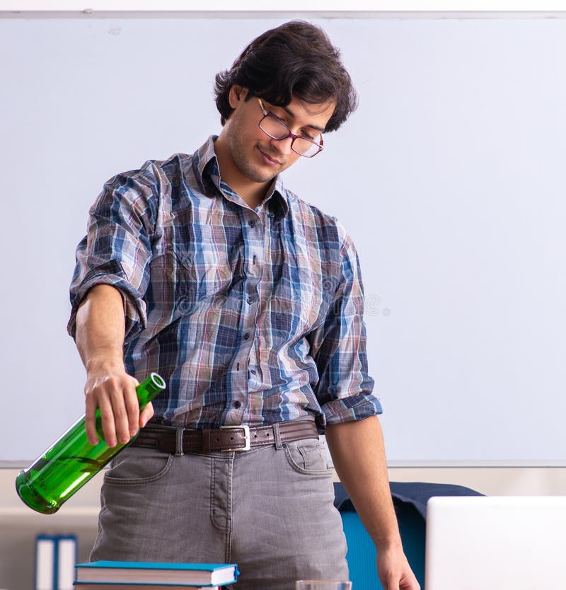 Male Teacher Drinking in the Classroom Stock Photo - Image of booze, glass: 295122290